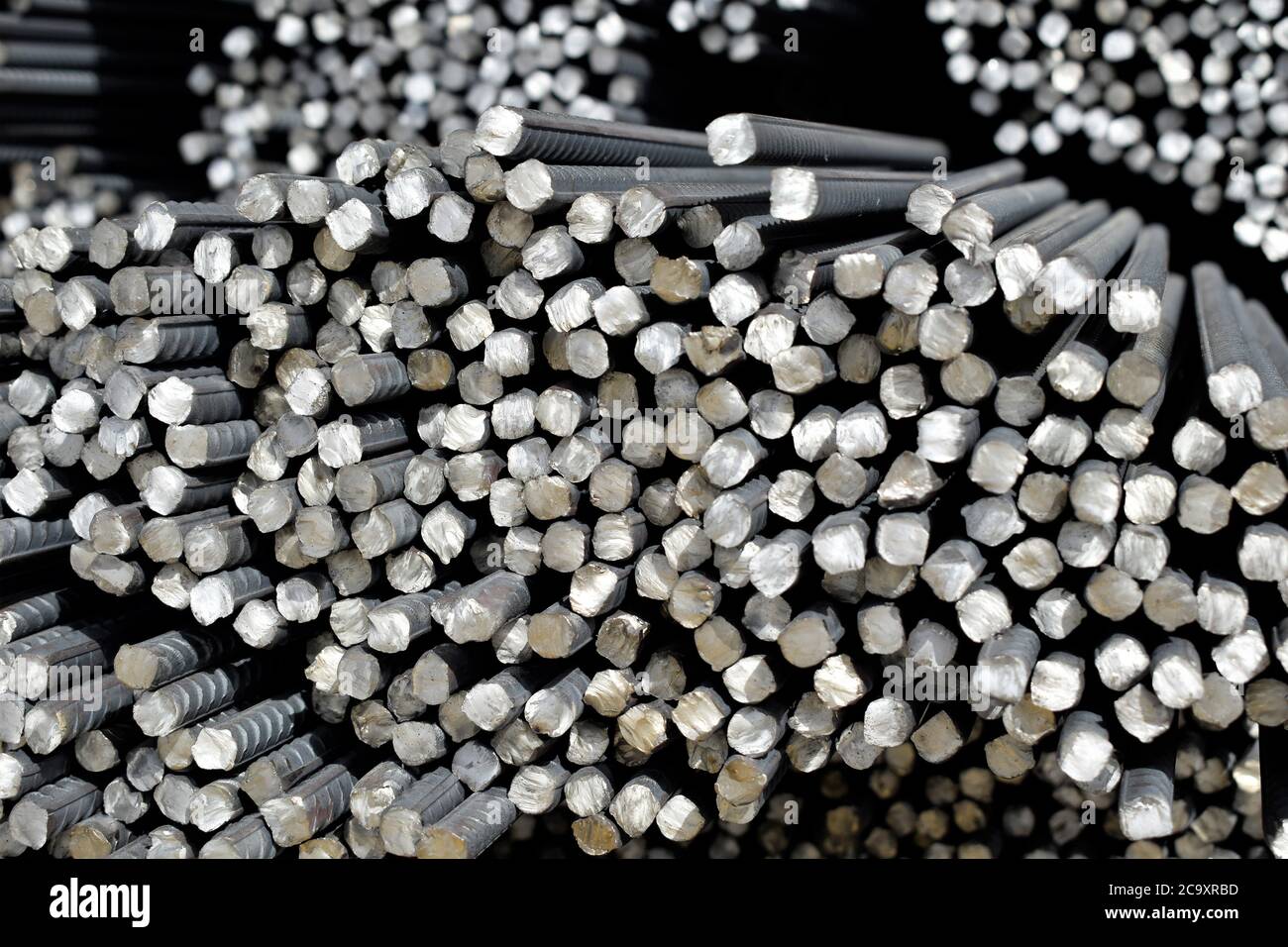 Rows of Steel rod storage and stacking in the warehouse for industrial ...