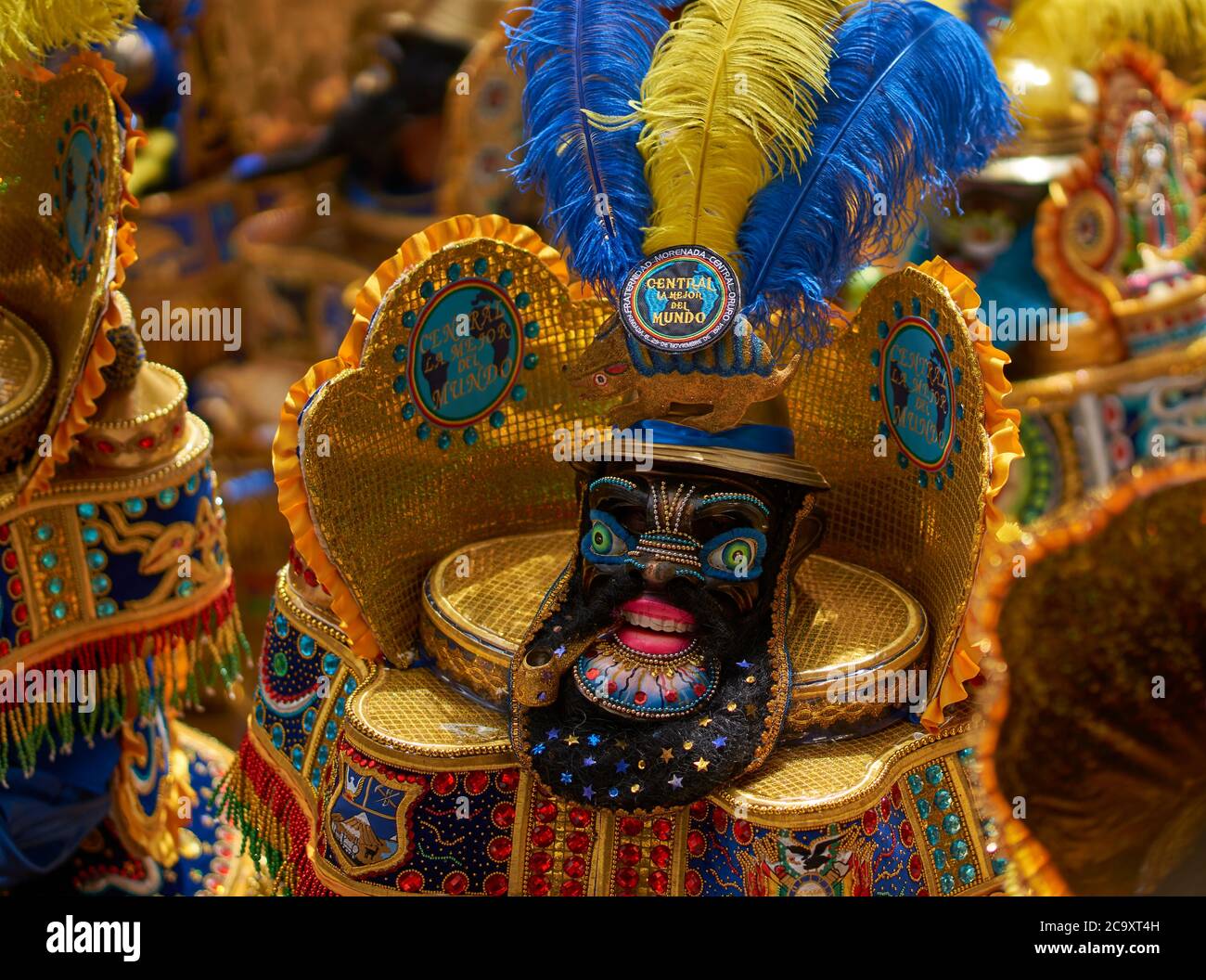 Masked morenada dancers in ornate costumes parade through the mining ...