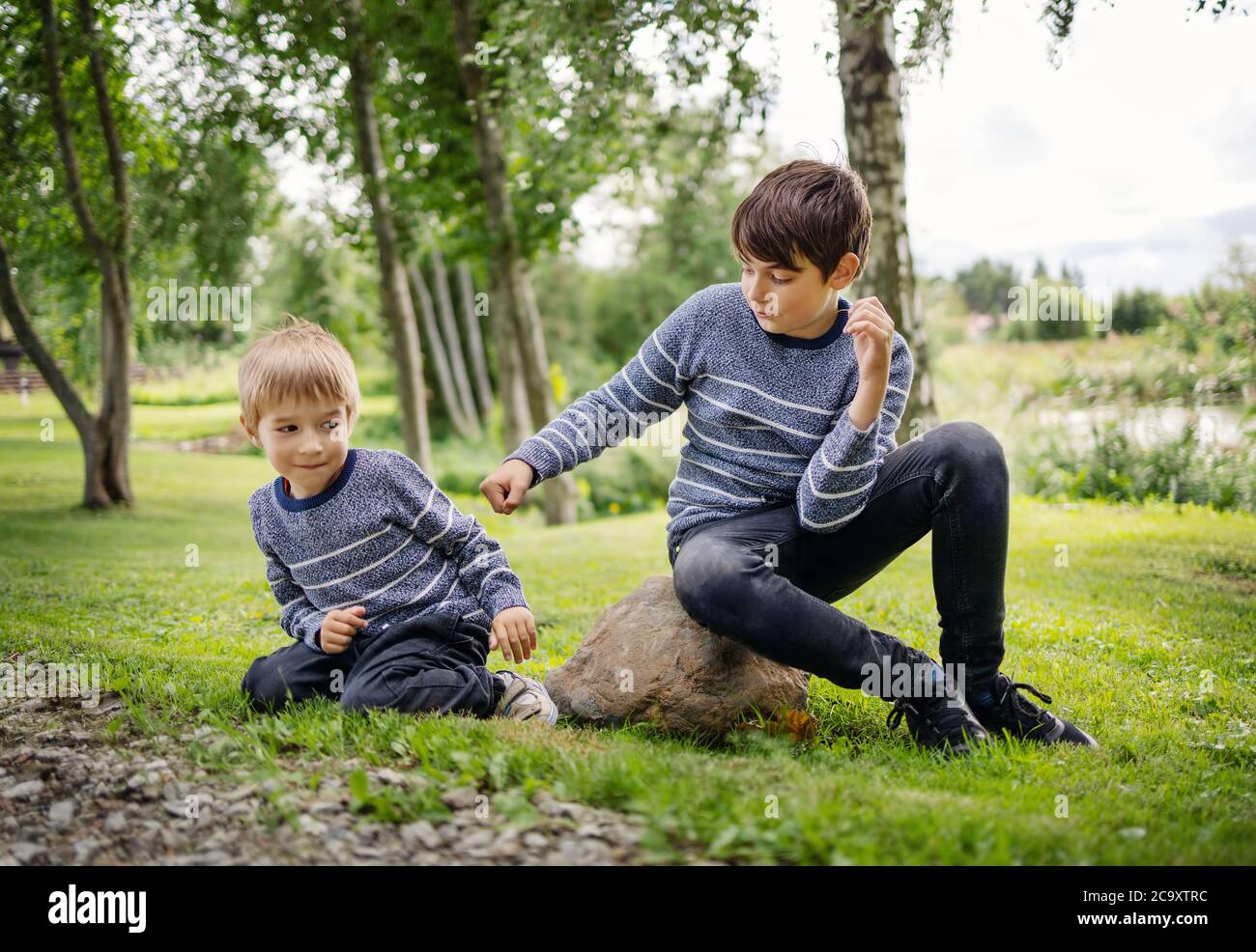 Two angry brothers fighting in park outdoors Stock Photo - Alamy