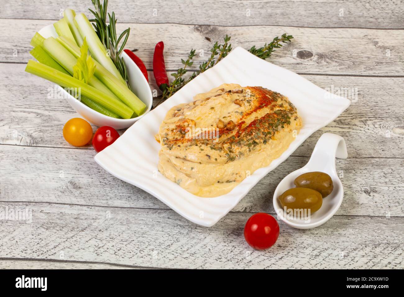 Vegan cuisine - Humus with celery sticks Stock Photo - Alamy