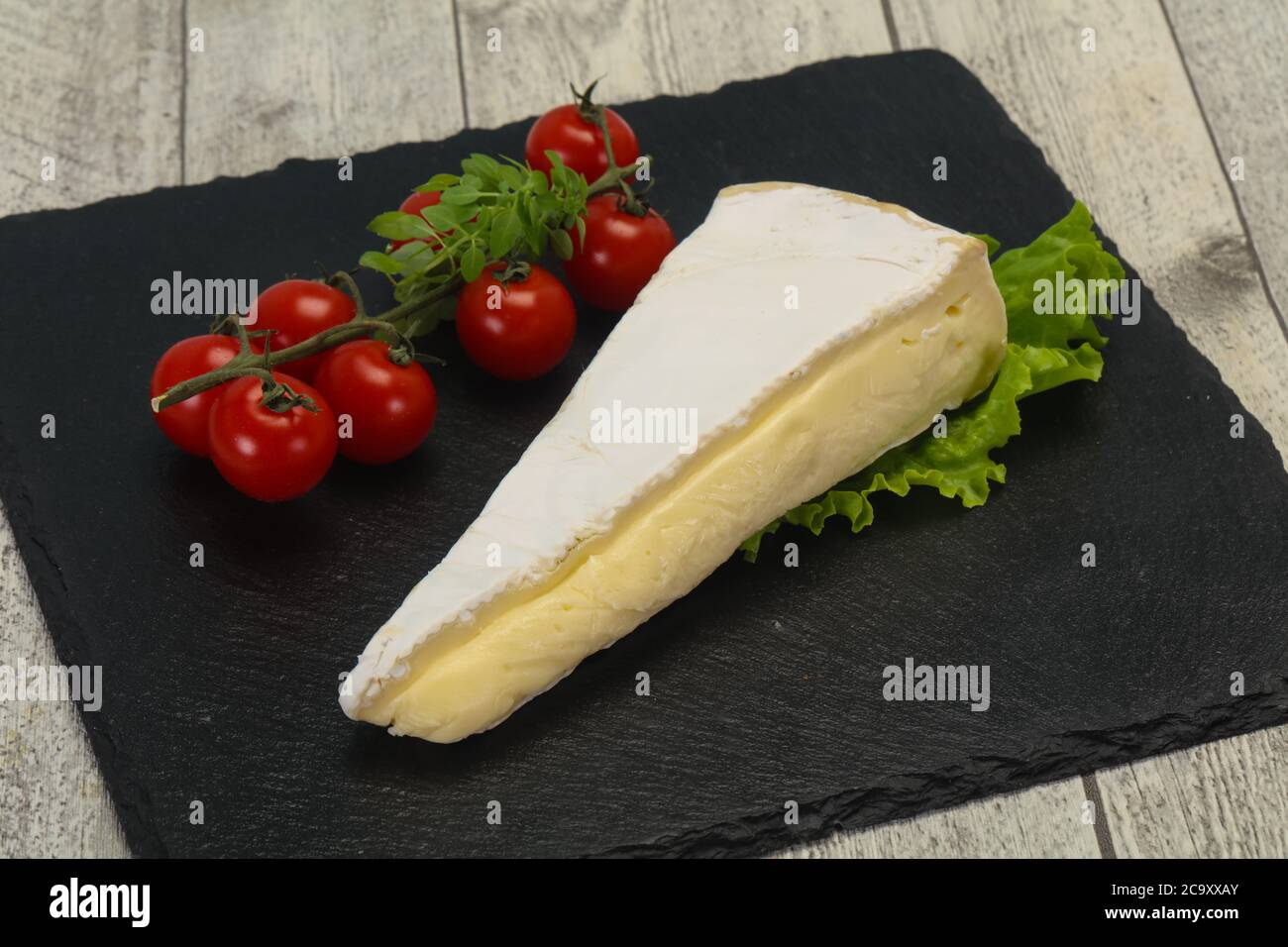 Brie cheese triangle served salad leaves Stock Photo - Alamy