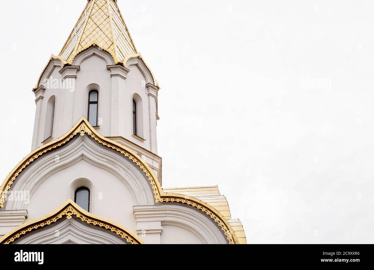 Beautiful design elements in a church, golden vaults and white walls ...