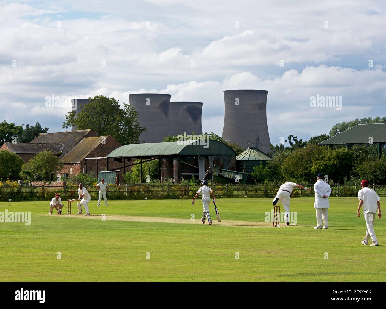 Cricket match in progress in the village of Drax, overlooked by the ...