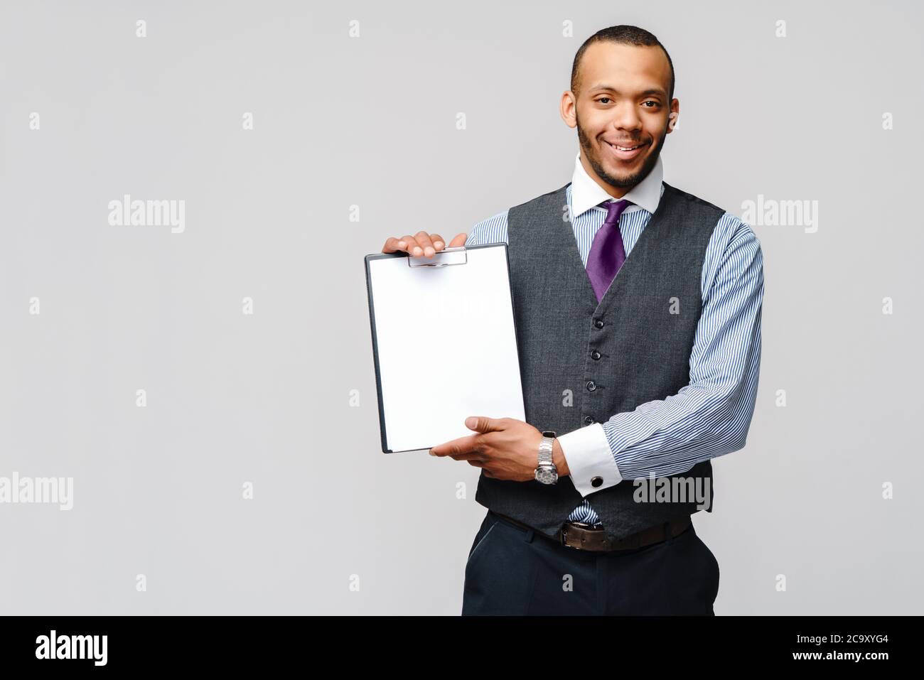a young african american man holding plain table tablet Stock Photo - Alamy