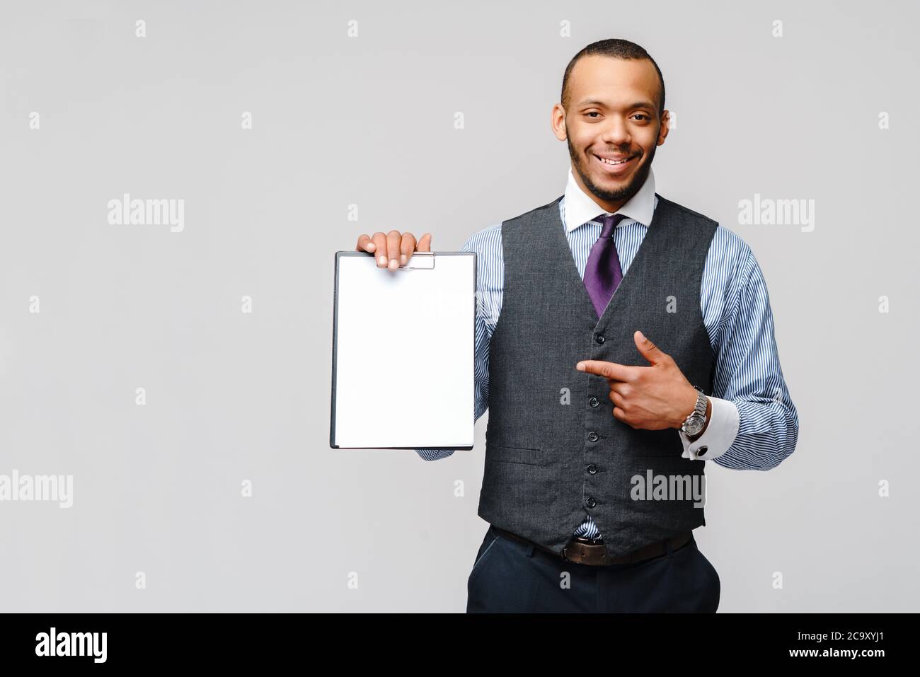 a young african american man holding plain table tablet Stock Photo - Alamy