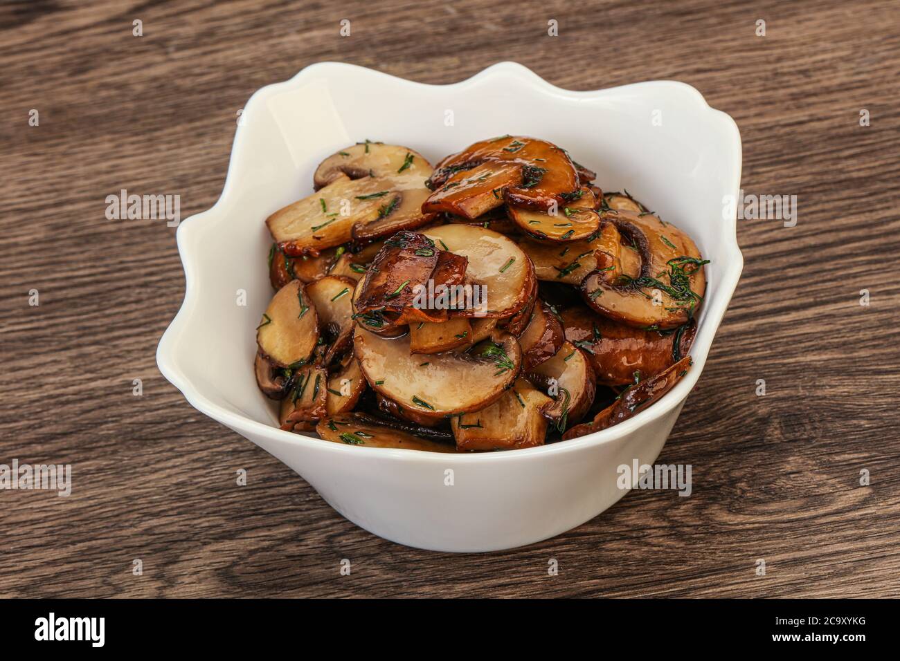 Roasted champignon with herbs and spices in the bowl Stock Photo - Alamy