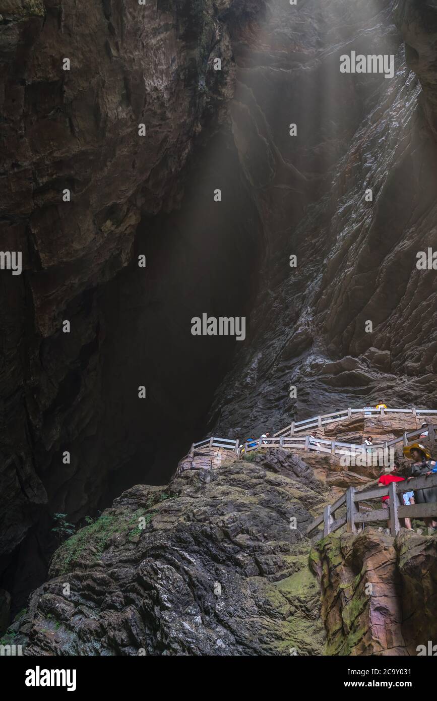 Wulong, China - August 2019 : Tourists climbing steps inside a stunning ...