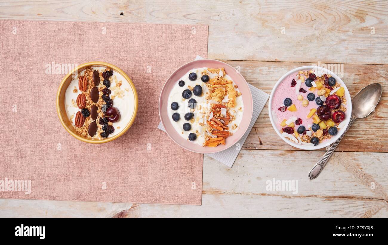 Bowls of yoghurt with various fruits and nuts Stock Photo - Alamy