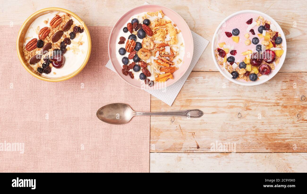 Bowls of yoghurt with various fruits and nuts Stock Photo - Alamy