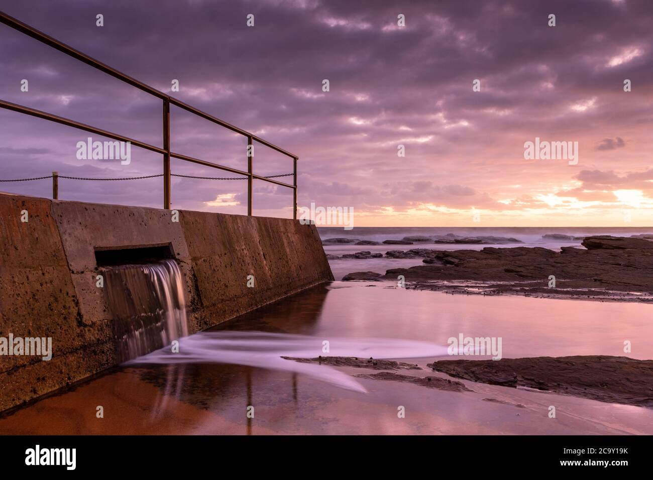 Water flowing from an ocean pool at sunrise in Collaroy, Australia ...