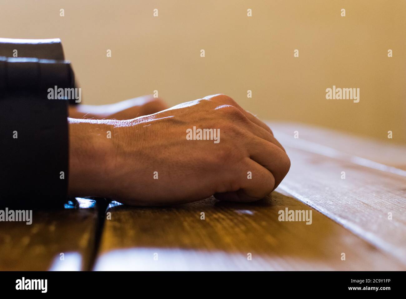 human hands handcuffs on wooden table ancient prison Stock Photo - Alamy