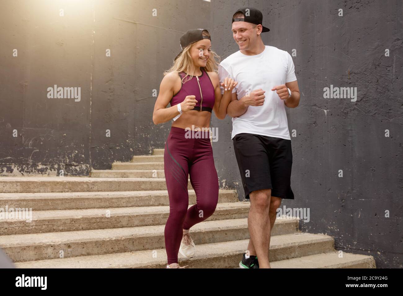 Two running people, sportive man and fit woman runners in active wear ...