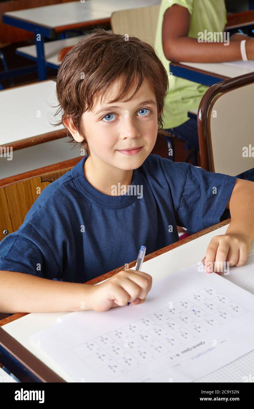 Student solves test with math problems in primary school Stock Photo ...