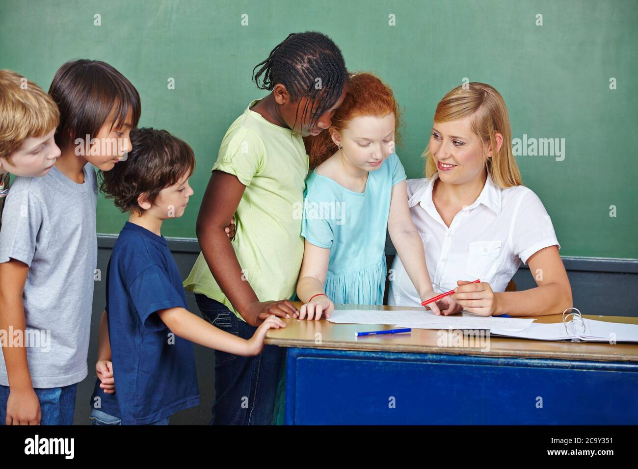 Teacher explains grading to students in a school classroom Stock Photo ...