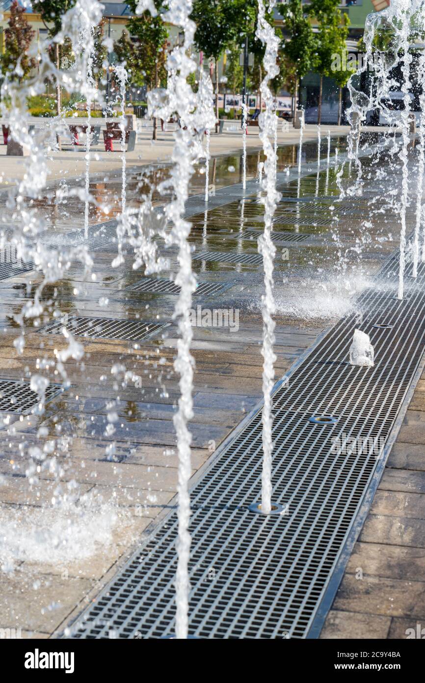 Vertical water streams of dry fountain, close up view. Streams flowing ...