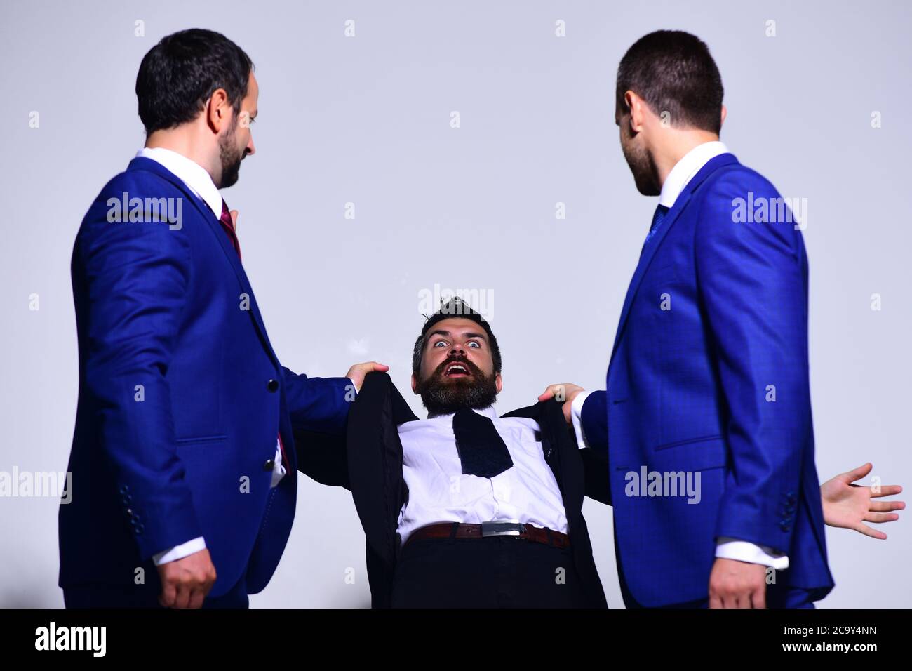 Company leaders fight for leadership. Businessmen with scared face and ...