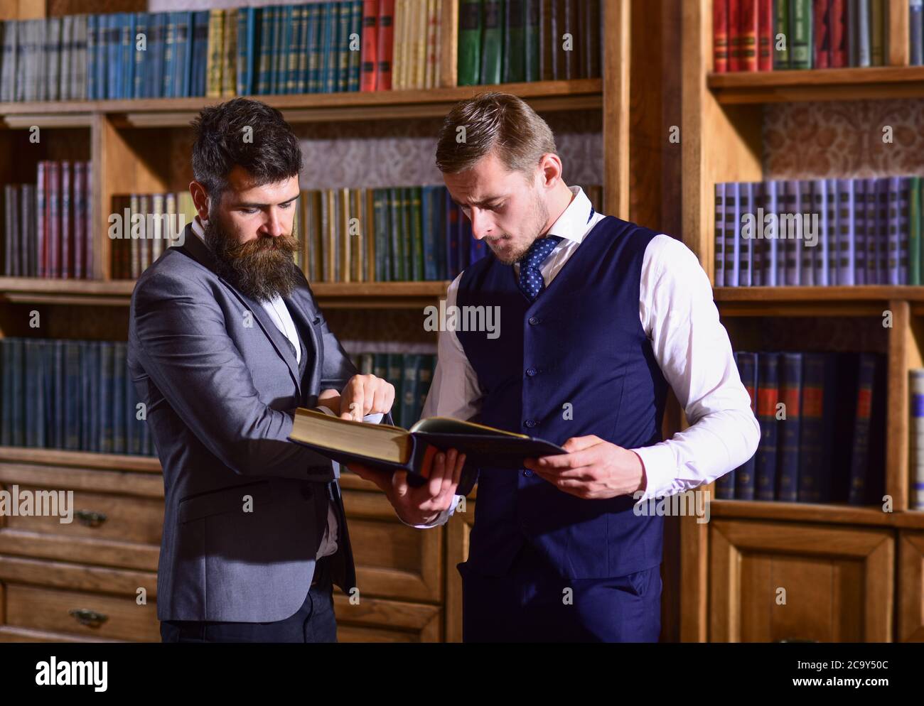 Intelligent men meet in library. Intelligent elite and scientific ...