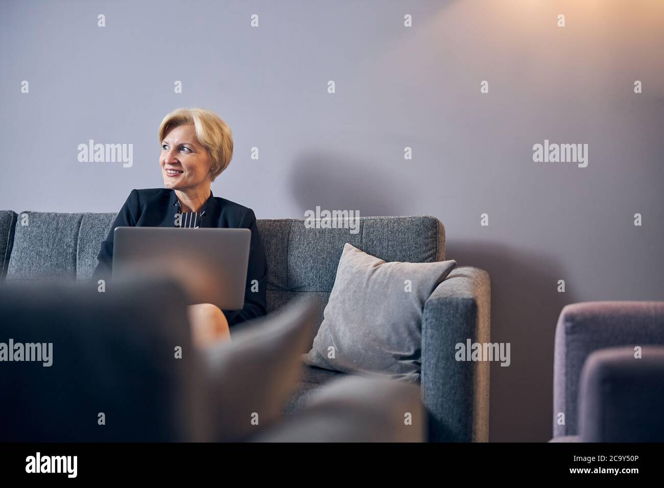 Beautiful businesswoman using notebook in hotel room Stock Photo - Alamy