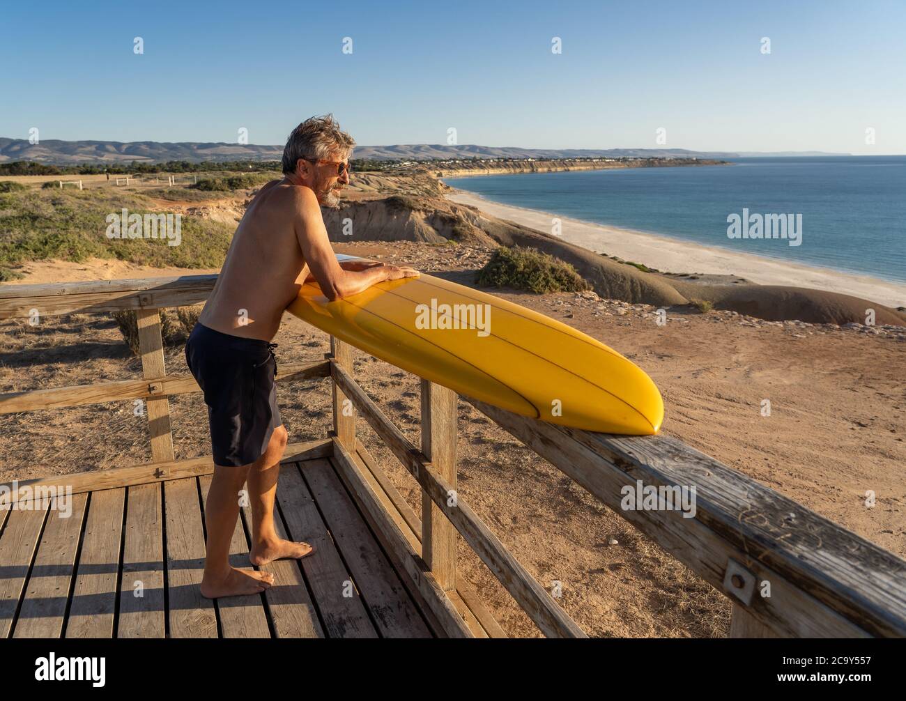 Attractive Australian mature man surfer with cool vintage surfboard on ...