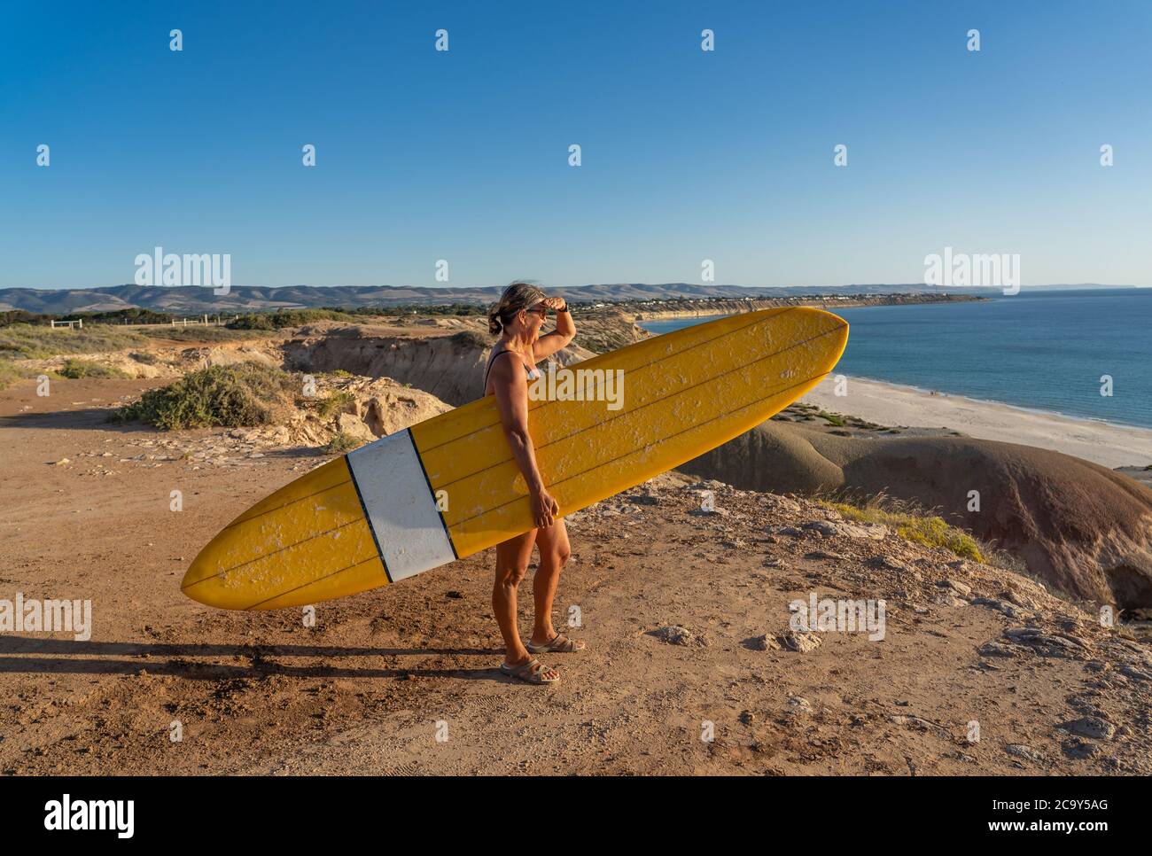 Attractive Australian mature surfer with cool vintage surfboard at ...