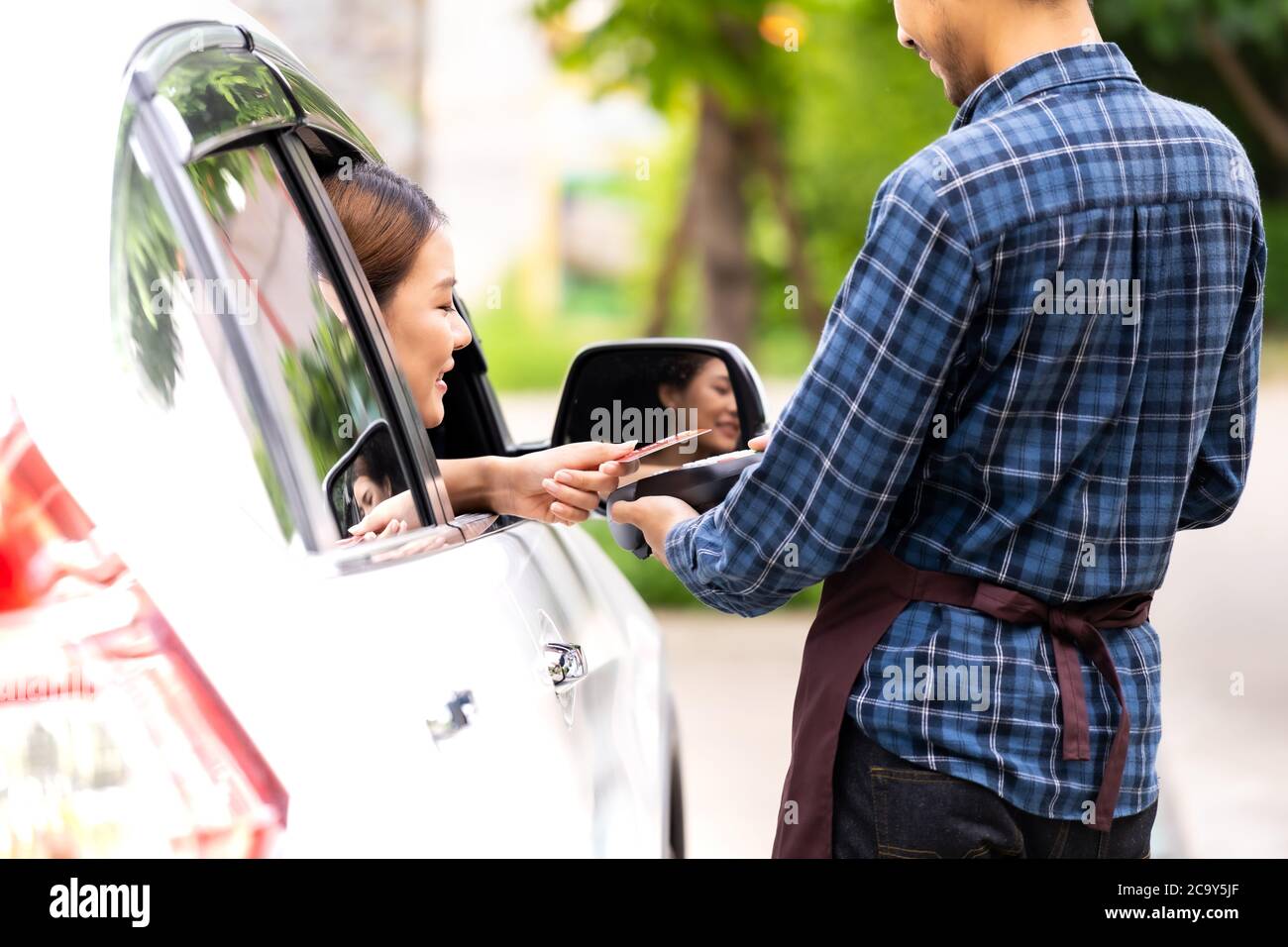 Back view of asian woman customer make mobile payment contactless ...