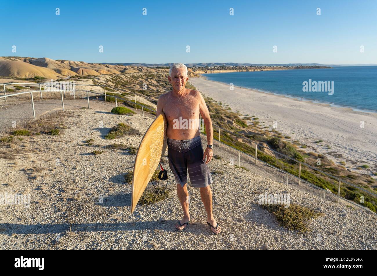 Attractive Australian mature man surfer with cool vintage surfboard on ...