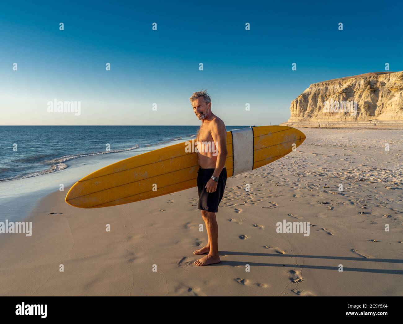 Attractive Australian mature man surfer with cool vintage surfboard on ...