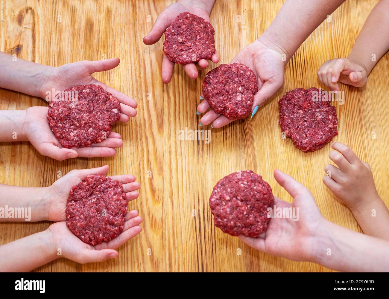 children hold raw minced meat patties in their hands, top view Stock ...