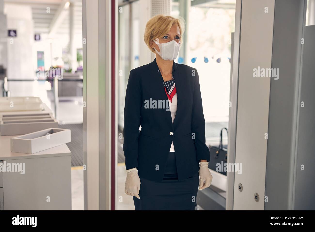 Charming businesswoman walking through check-in gate at airport Stock ...
