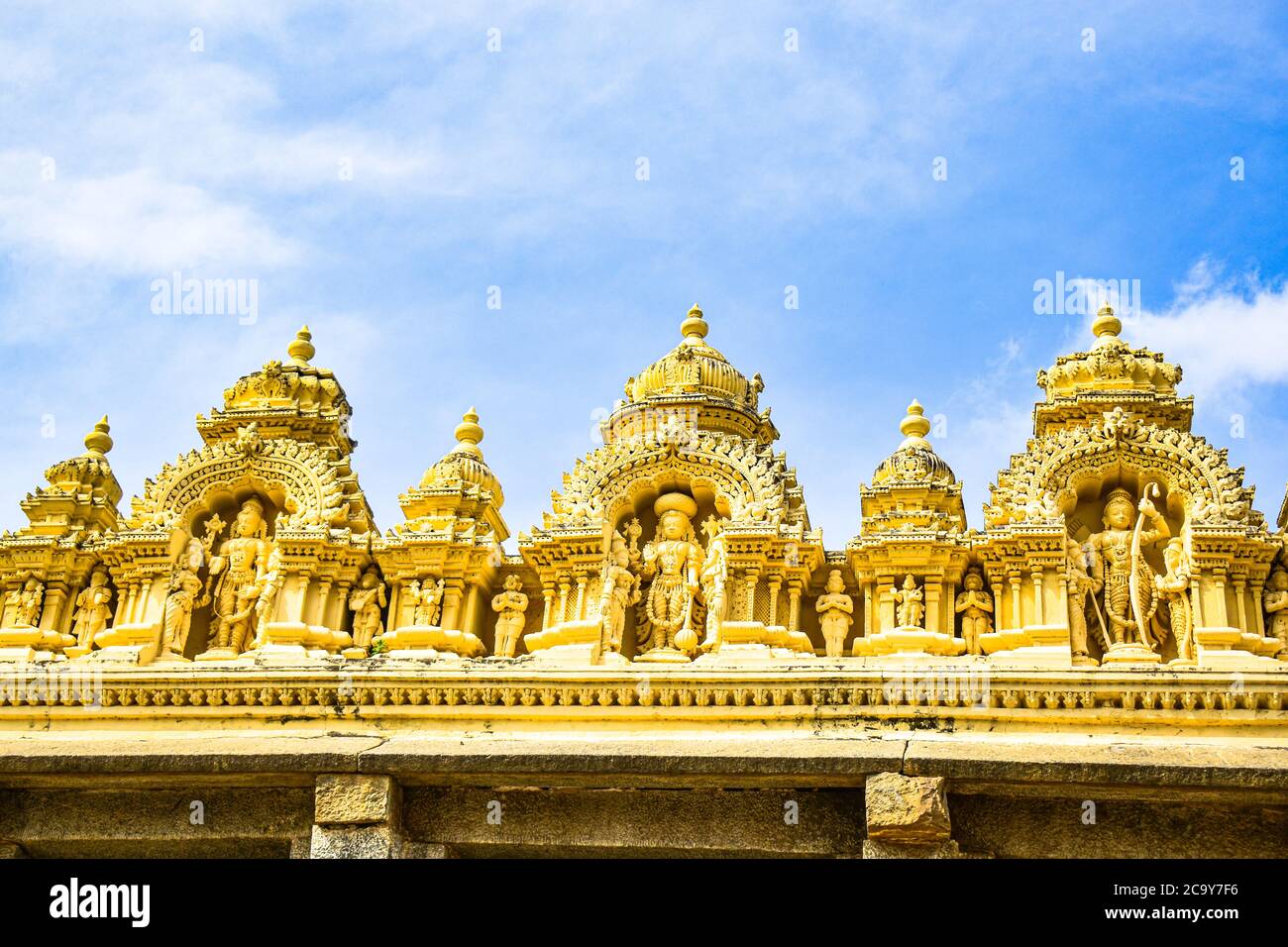 The portrait view of a structure on the top of a temple with blue sky ...