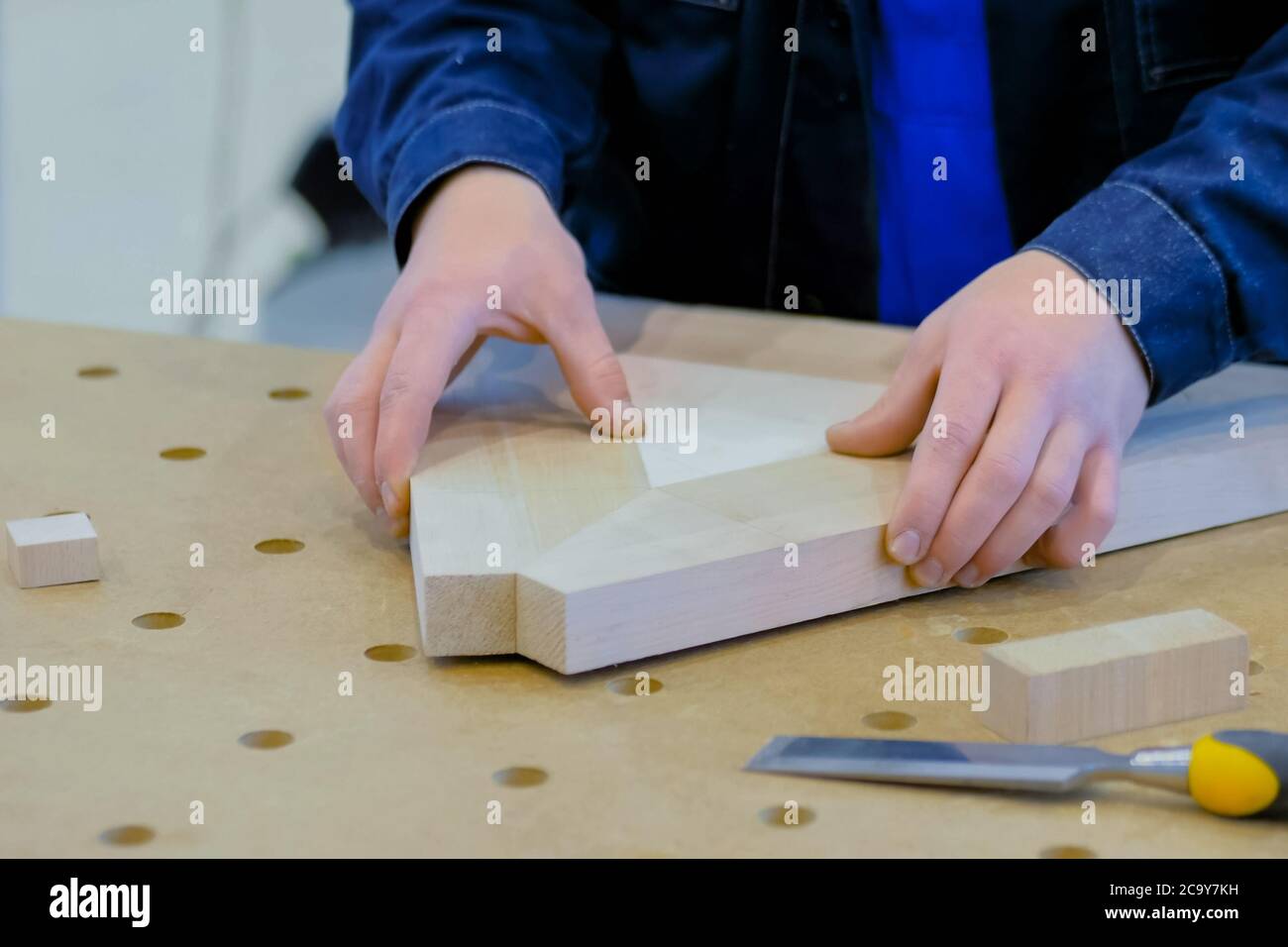 Professional man carpenter working with wooden details on rough ...