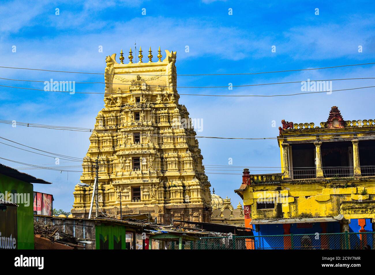 The full frame picture of a temple with buildings nearby and wires in ...