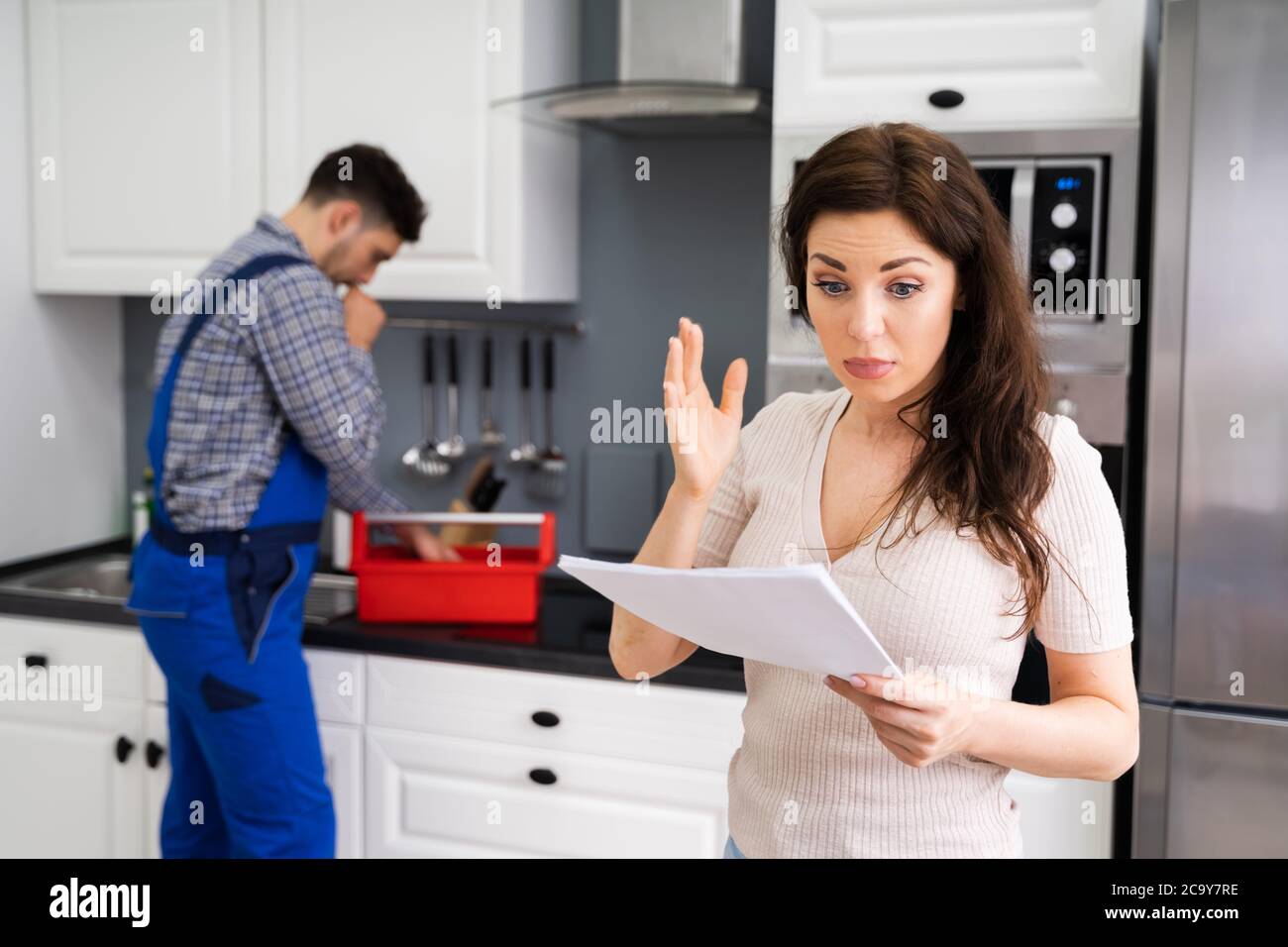 Customer Woman With Expensive Repairs Invoice At Home Stock Photo - Alamy
