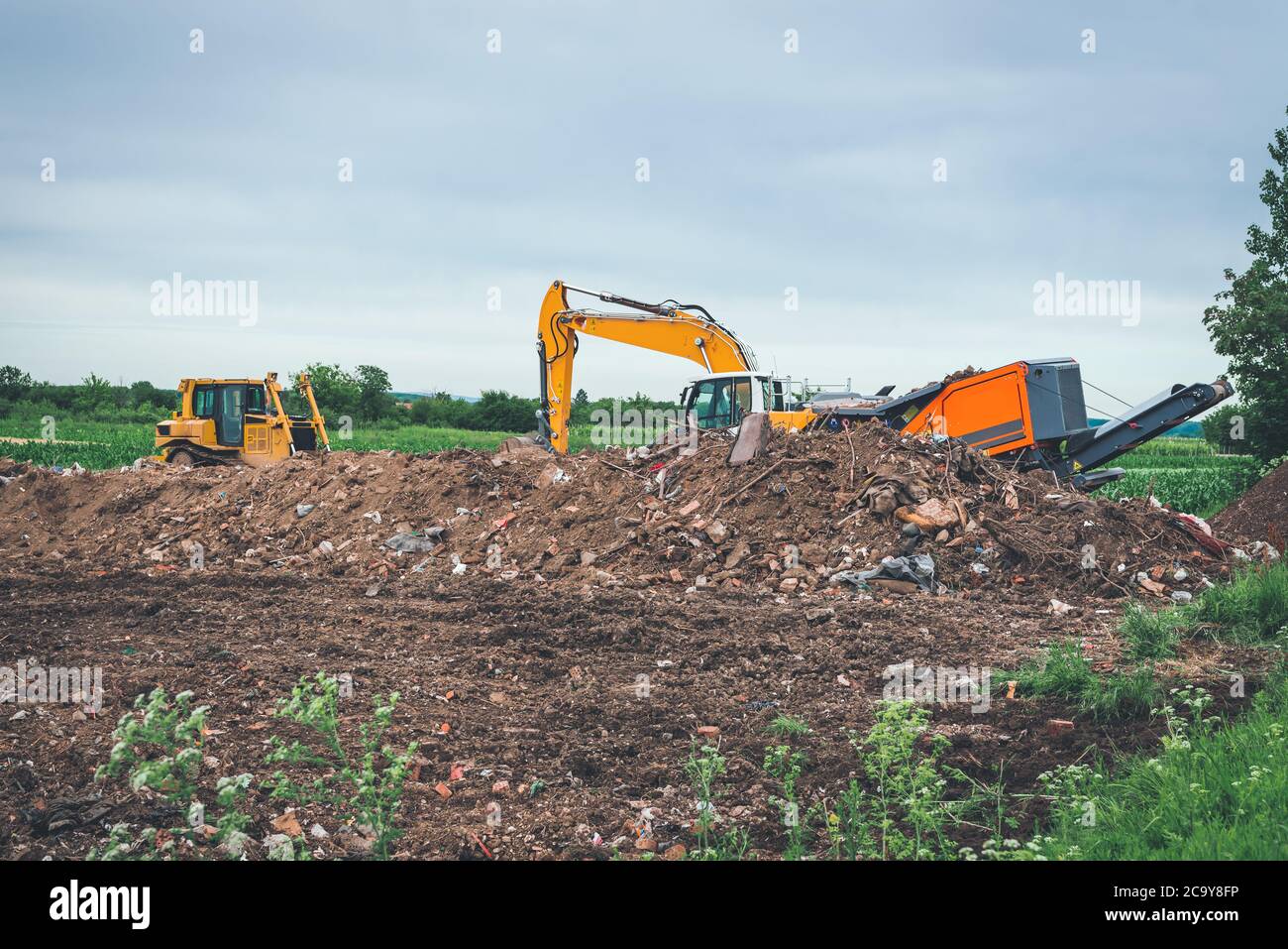 industrial machines clean the landfill and produce fine waste Stock ...
