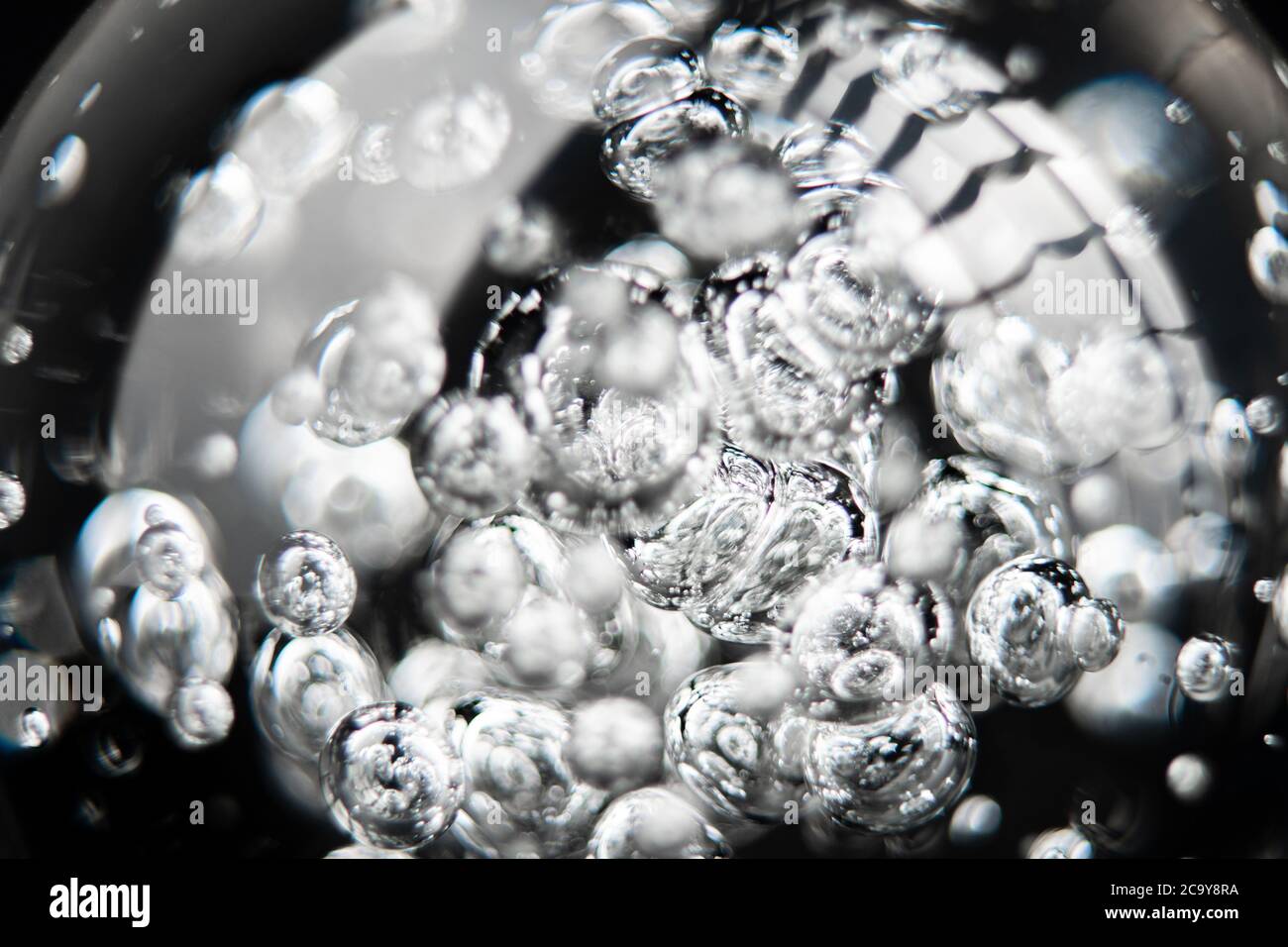 Bubbles in glass transparent ball on black background Stock Photo - Alamy