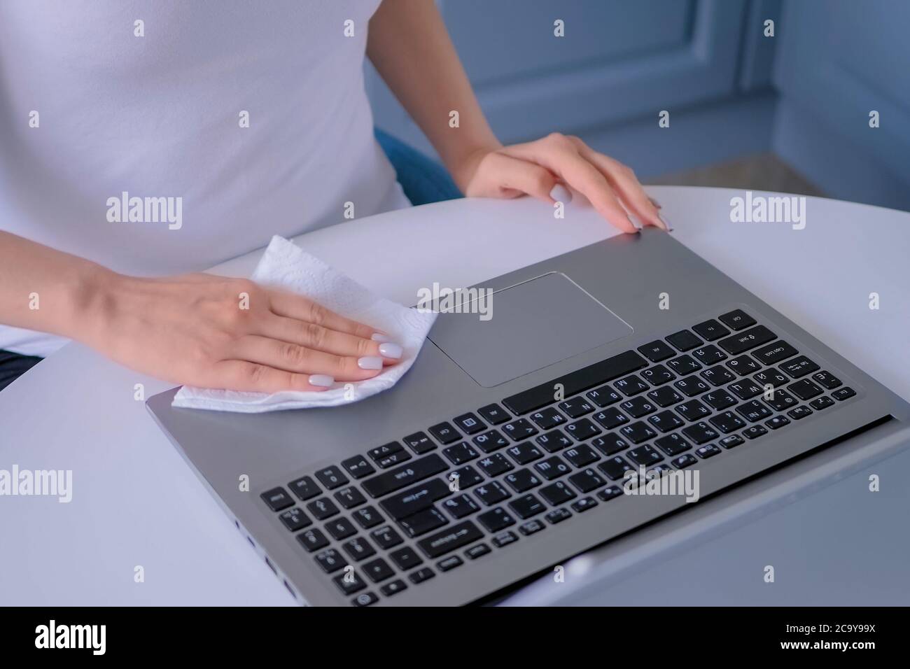 Woman hands cleaning laptop keyboard with antiseptic disinfectant wet ...