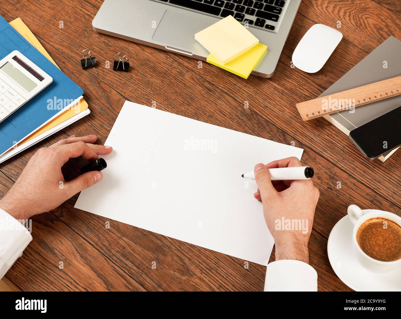Man writing on paper Stock Photo - Alamy