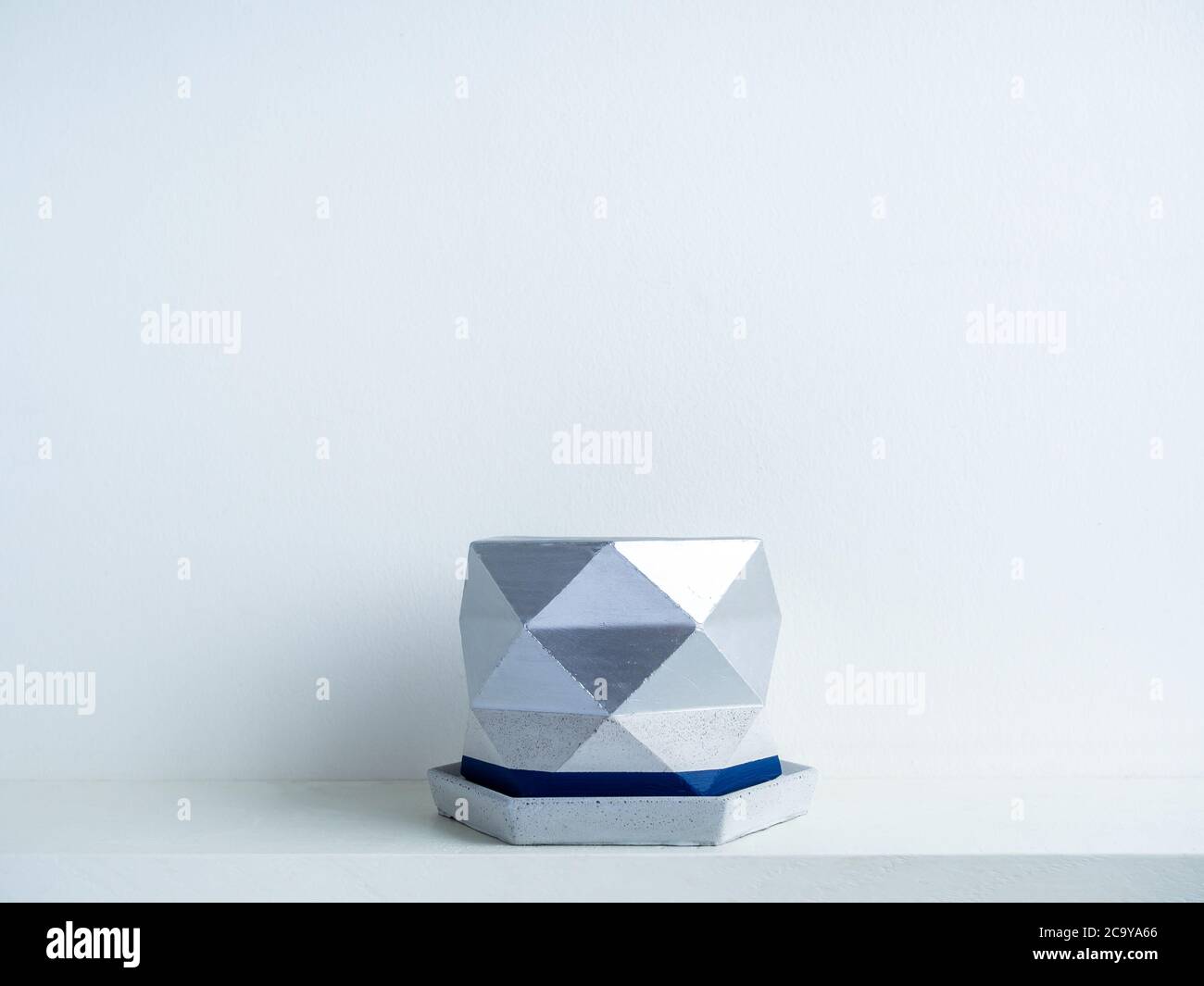 Empty modern geometric concrete planter on white shelf isolated on ...