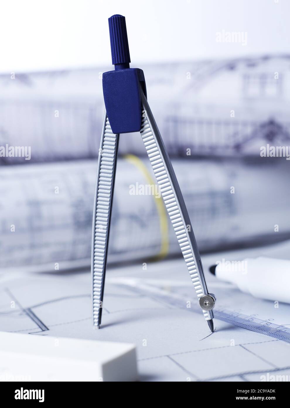 Drawing compass on blueprints Stock Photo - Alamy