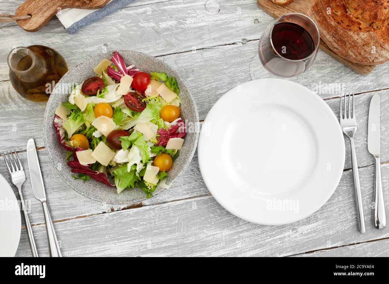 Empty plate on dinner table Stock Photo - Alamy