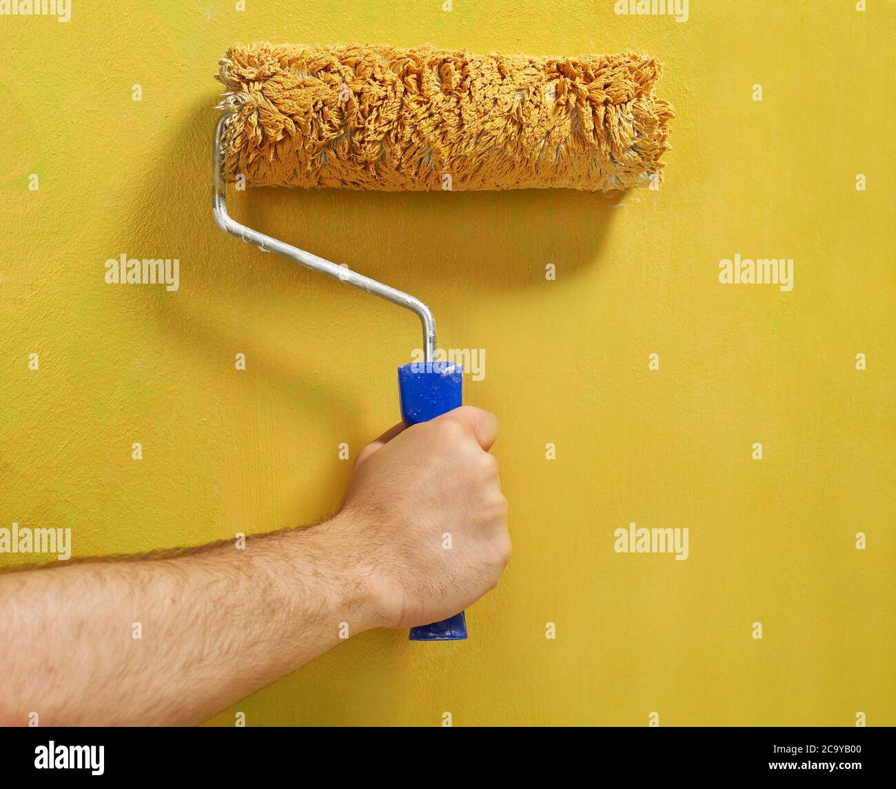 Hand with paint roller Stock Photo - Alamy