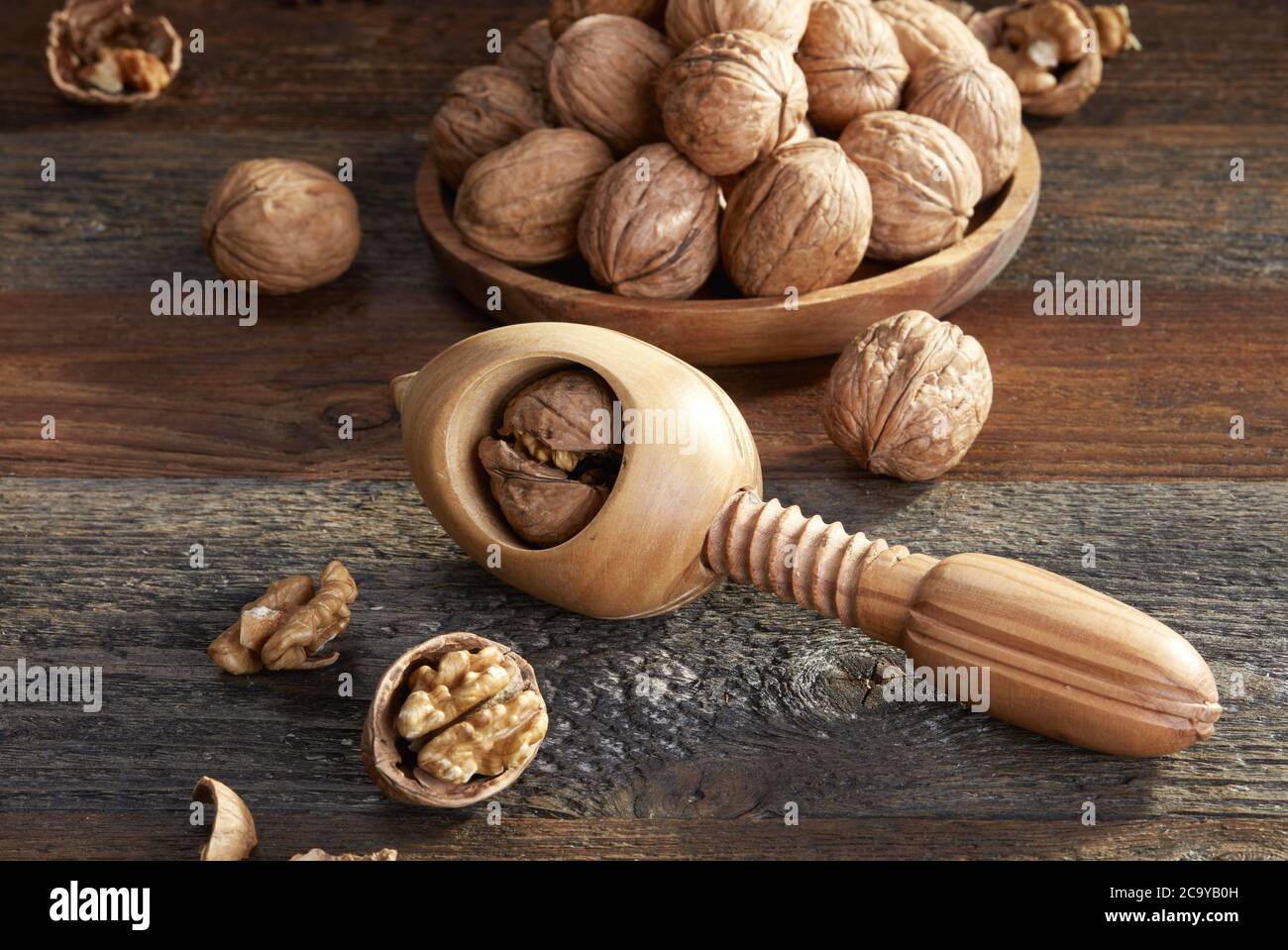 Nutcracker and walnuts on wooden background Stock Photo - Alamy