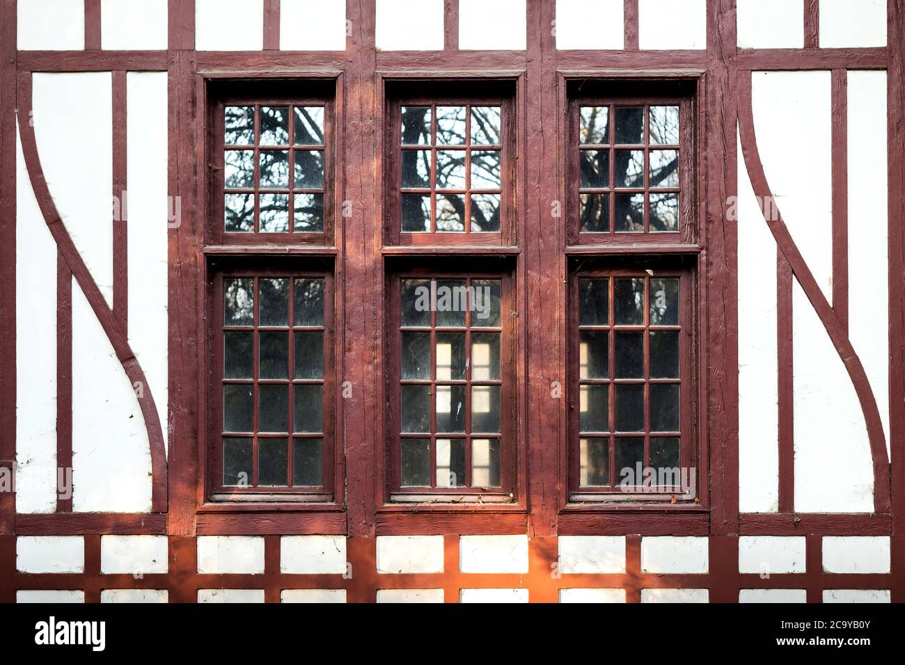 Eye-level shot of the facade of a building with a window with a wooden ...