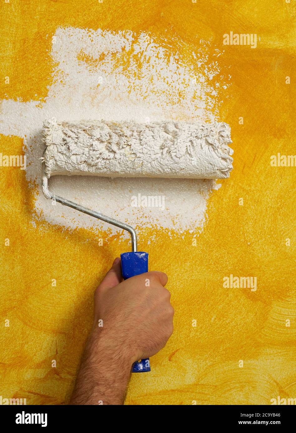 Hand with paint roller Stock Photo - Alamy