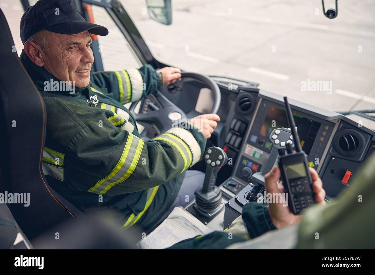 Smiling handsome driver is listening his colleagues Stock Photo - Alamy