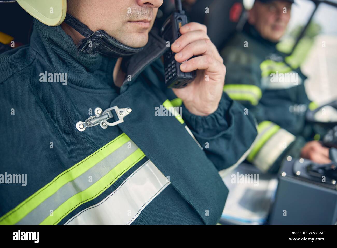 Portrait of seriously man talking with colleagues on the walkie Stock ...