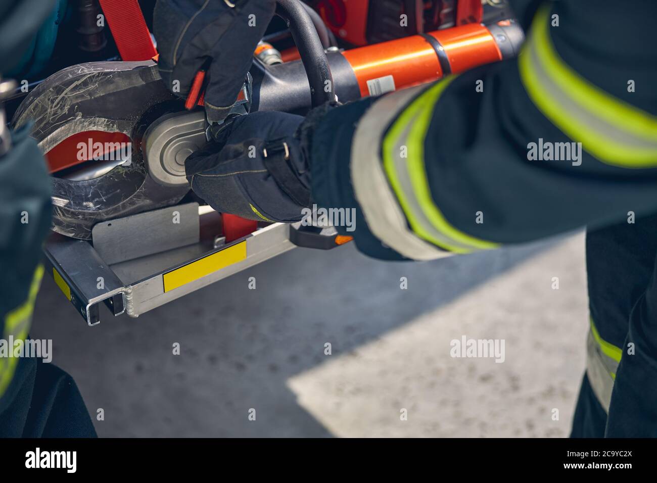 Firefighter is installing equipment on the fire truck Stock Photo - Alamy