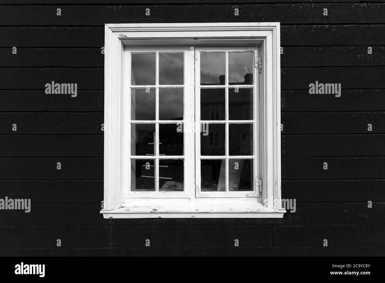 Eye-level shot of the facade of a black building with a window with a ...