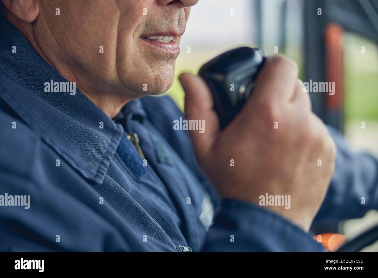 Man holding radio in his hand while sitting in the fire truck Stock ...