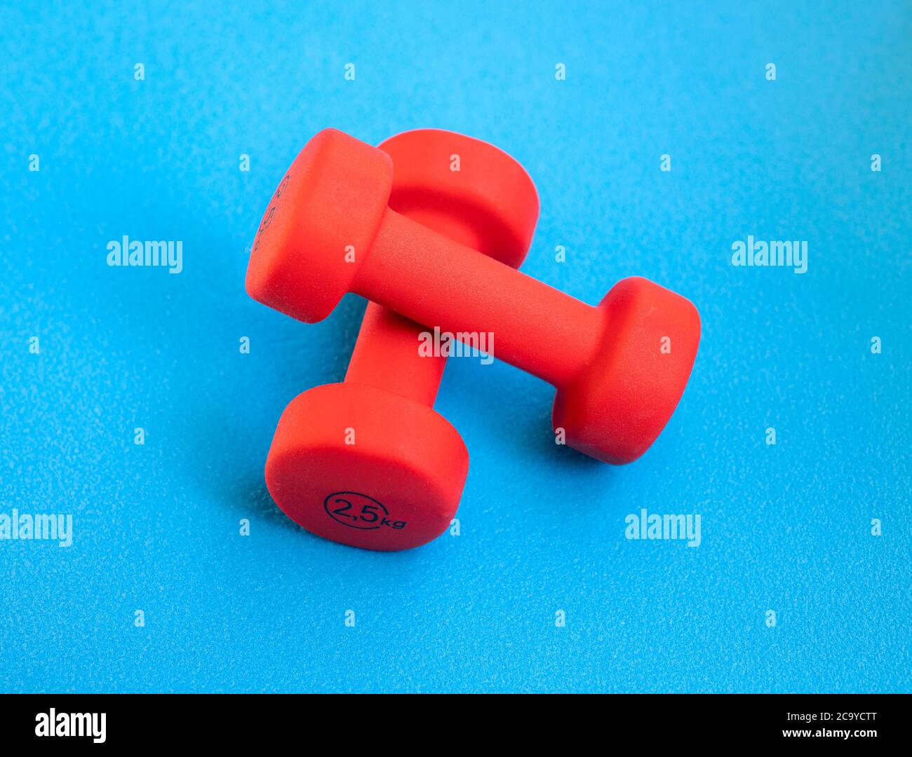 Red weights on the blue background Stock Photo - Alamy